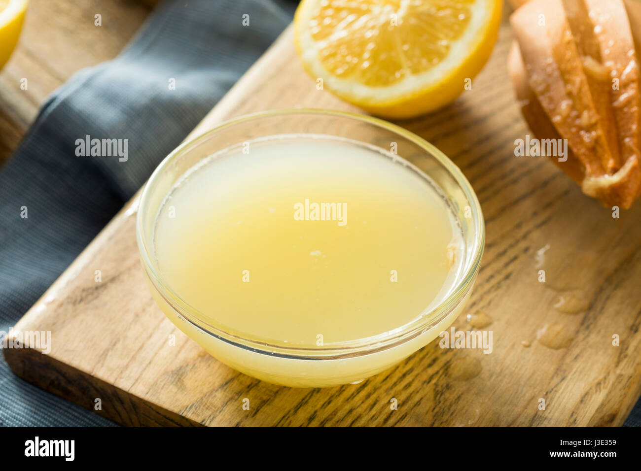 Raw Organic Yellow Lemon Juice in a Bowl Stock Photo - Alamy