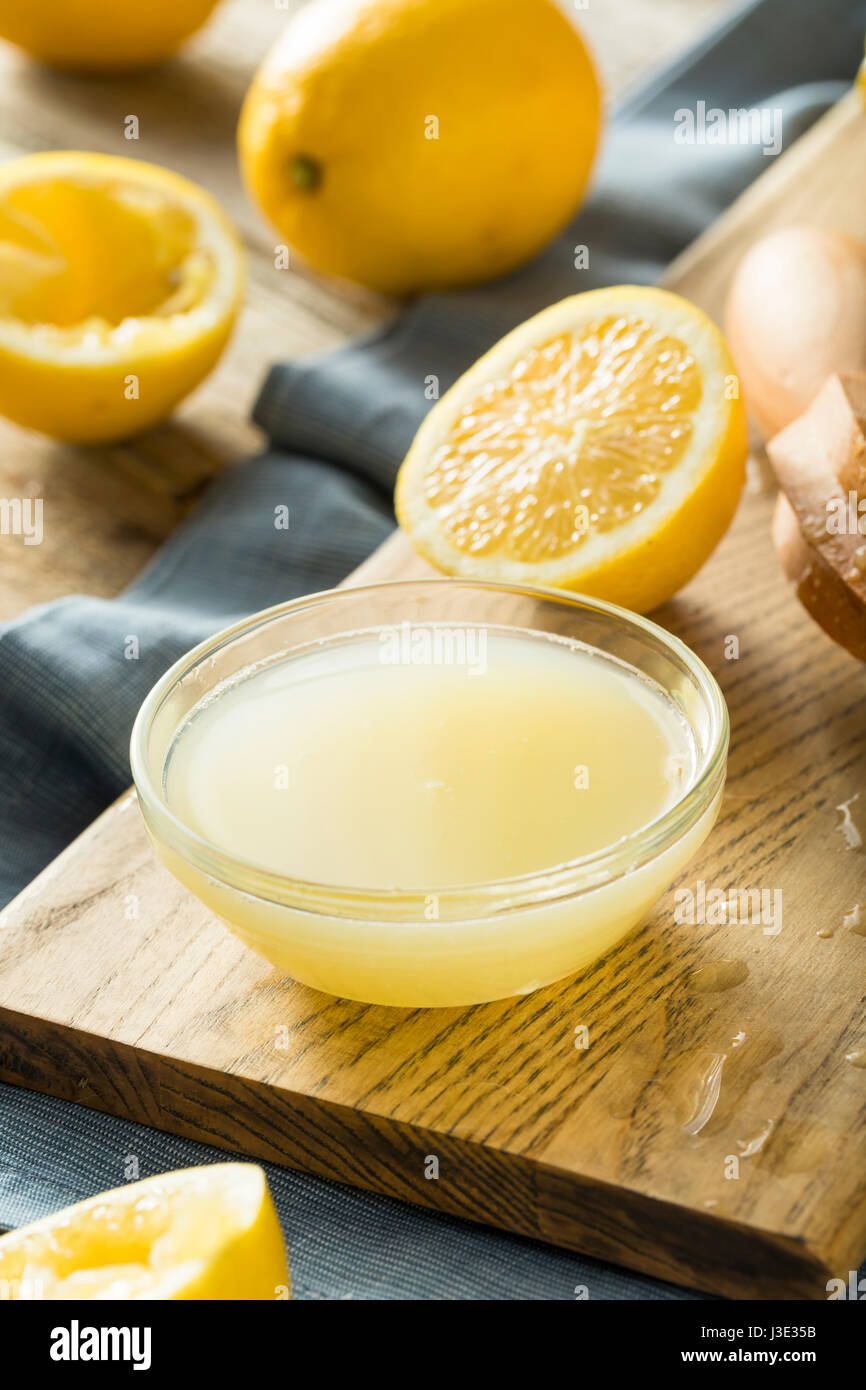 Raw Organic Yellow Lemon Juice in a Bowl Stock Photo - Alamy