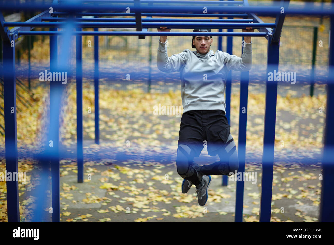 Doing Exercises on Horizontal Bar Stock Photo - Alamy