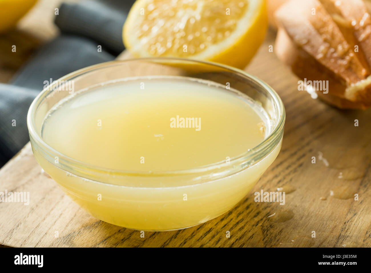 Raw Organic Yellow Lemon Juice in a Bowl Stock Photo - Alamy