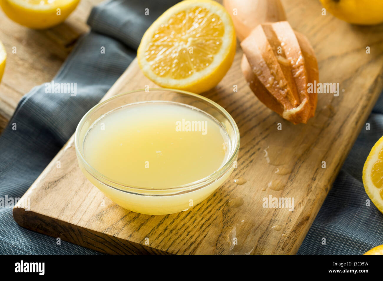 Raw Organic Yellow Lemon Juice in a Bowl Stock Photo - Alamy
