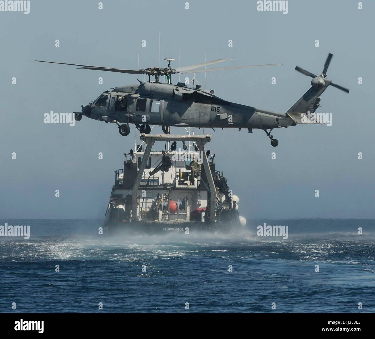 U.S. sailors descend from a USN MH-60S Seahawk helicopter during a ...