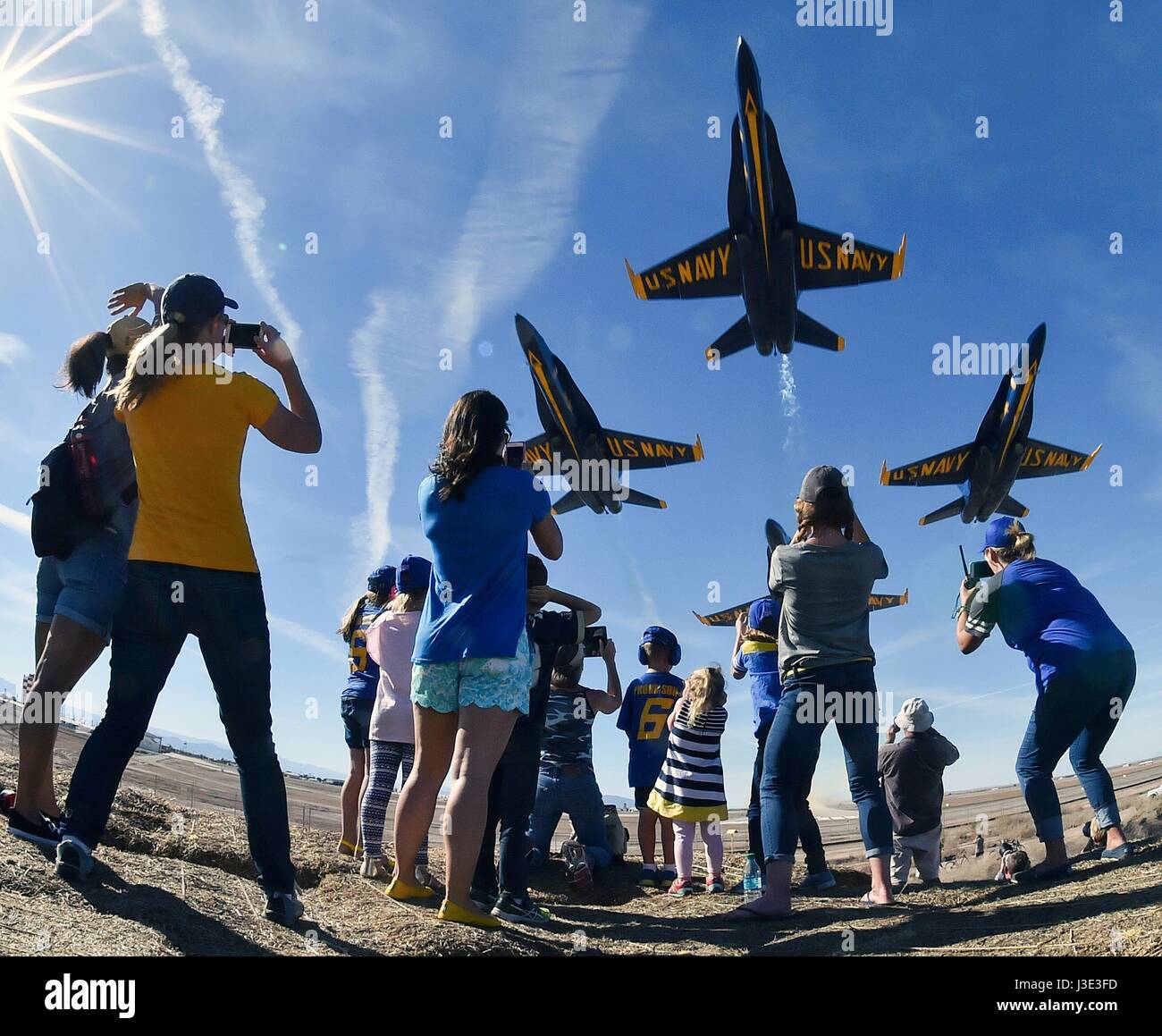 Spectators watch the USN Blue Angels aerial demonstration squadron fly ...