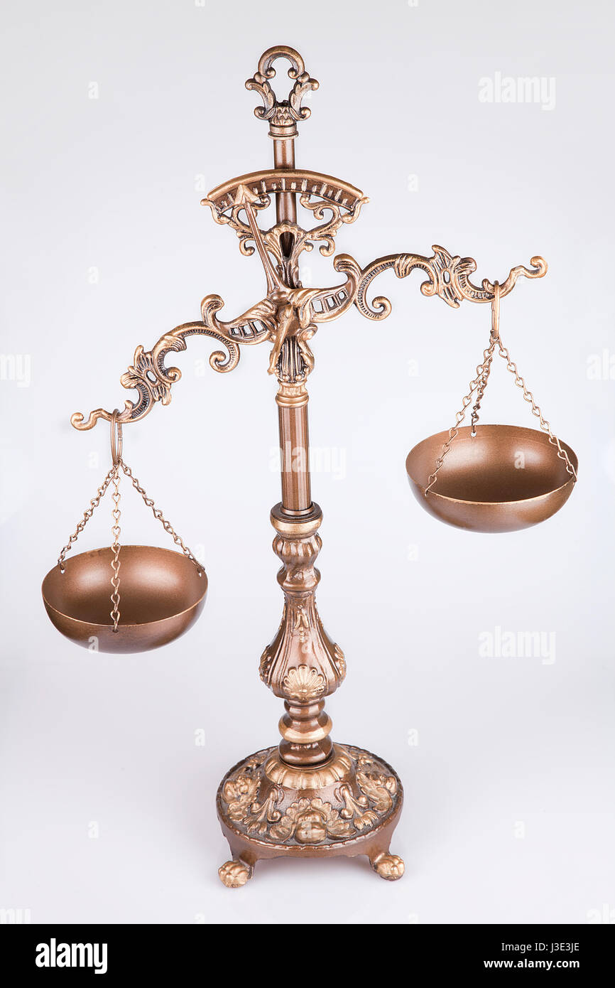 Intricate brass balance on a white surface. Scale isolated on white ...