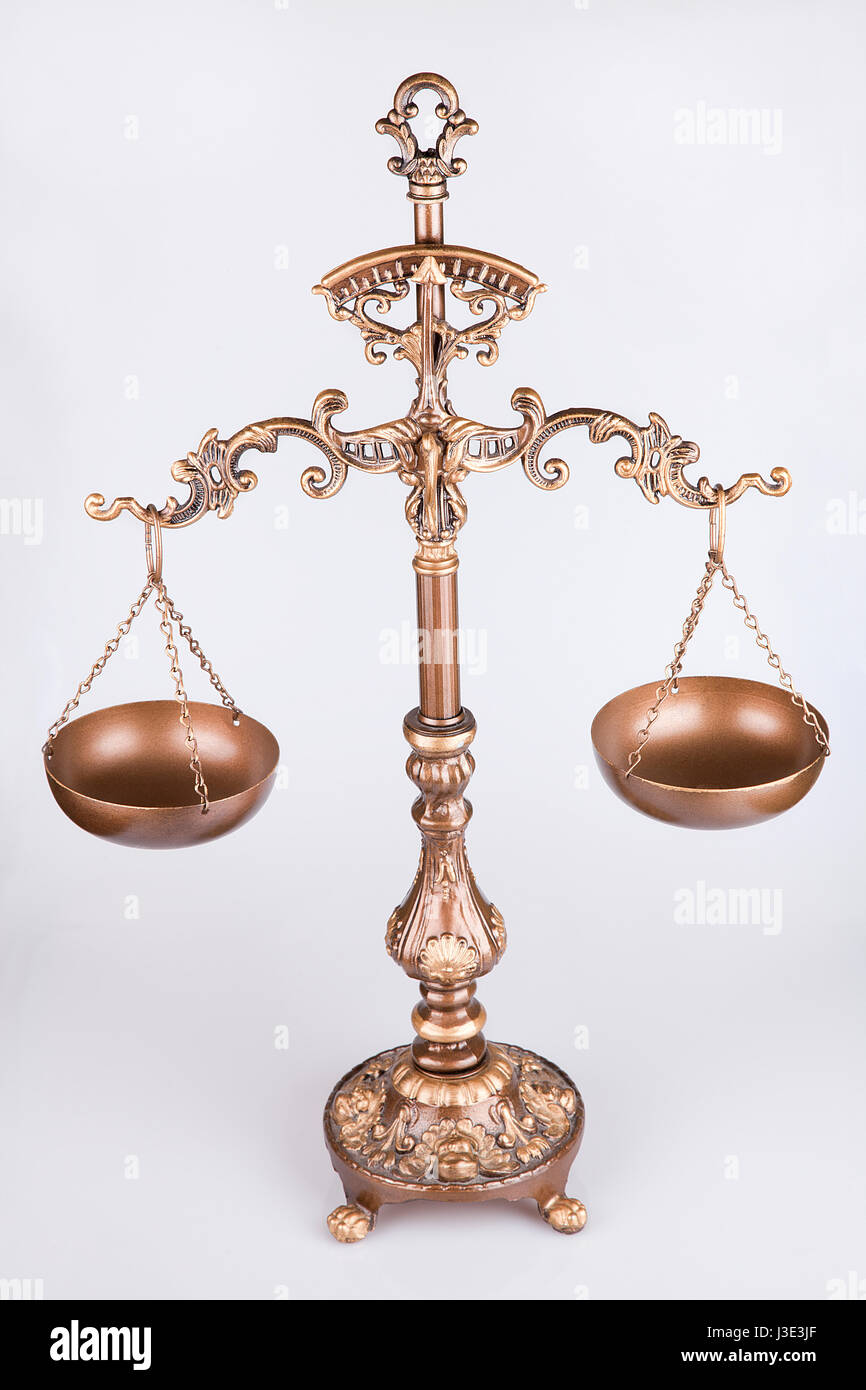 Intricate brass balance on a white surface. Scale isolated on white ...