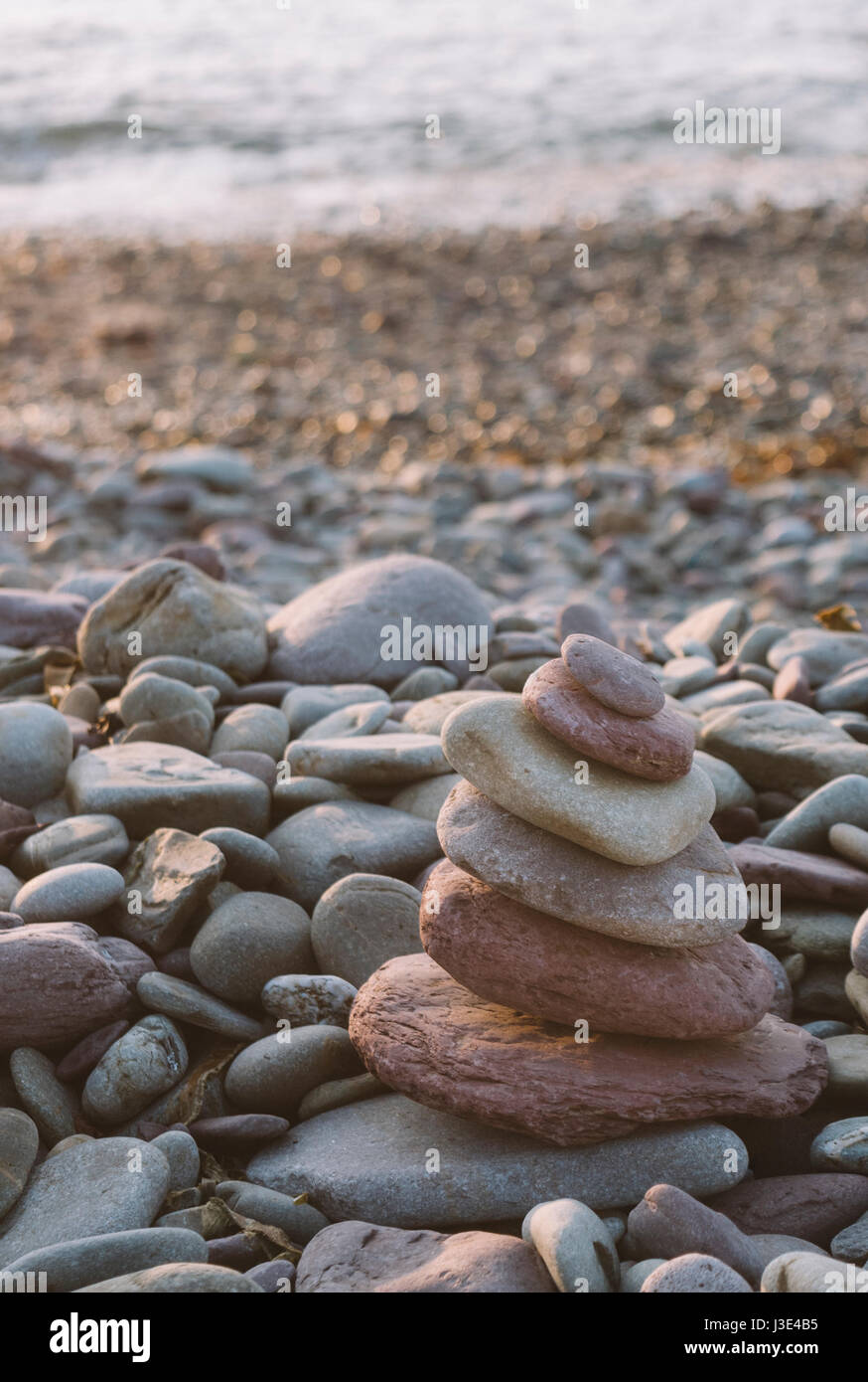 Stacked Stones on Beach Stock Photo - Alamy