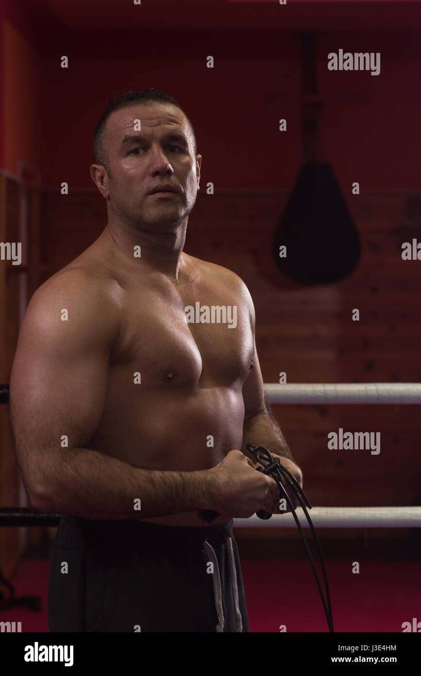 portrait of muscular professional kickboxer who standing in the ring ...