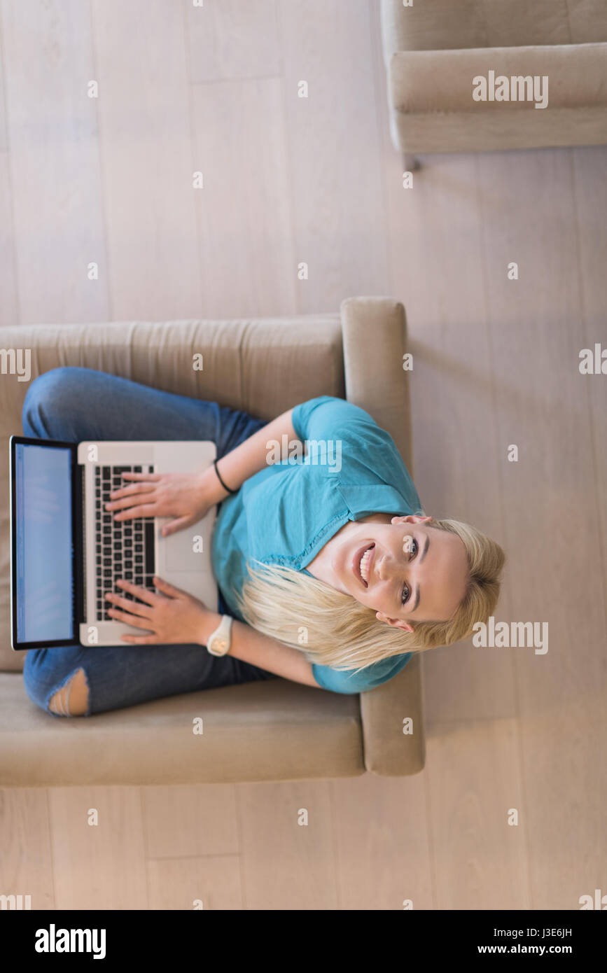 Young woman using her laptop computer in her luxury modern home top ...