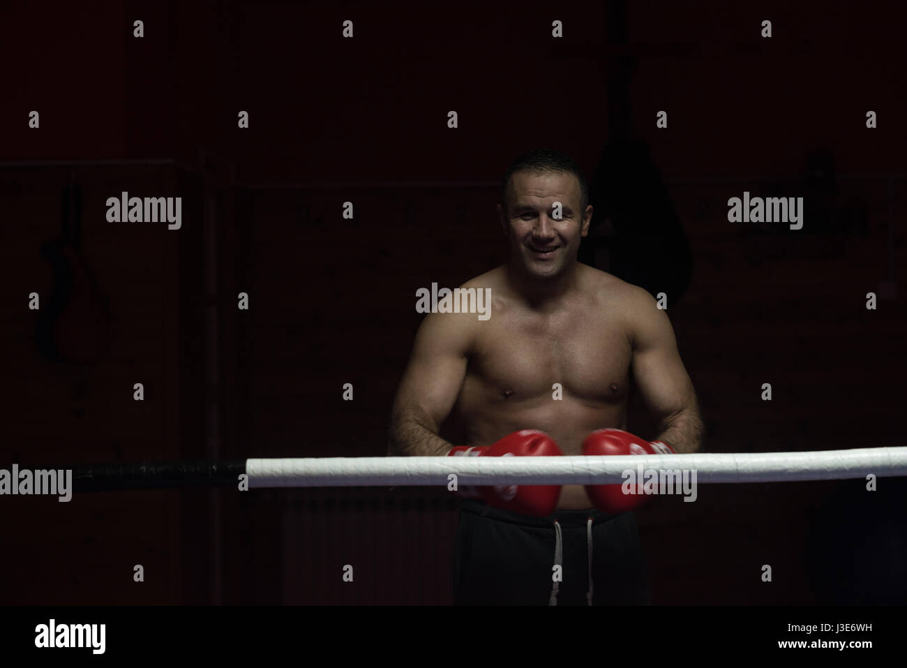 portrait of muscular professional kickboxer who standing in the ring ...