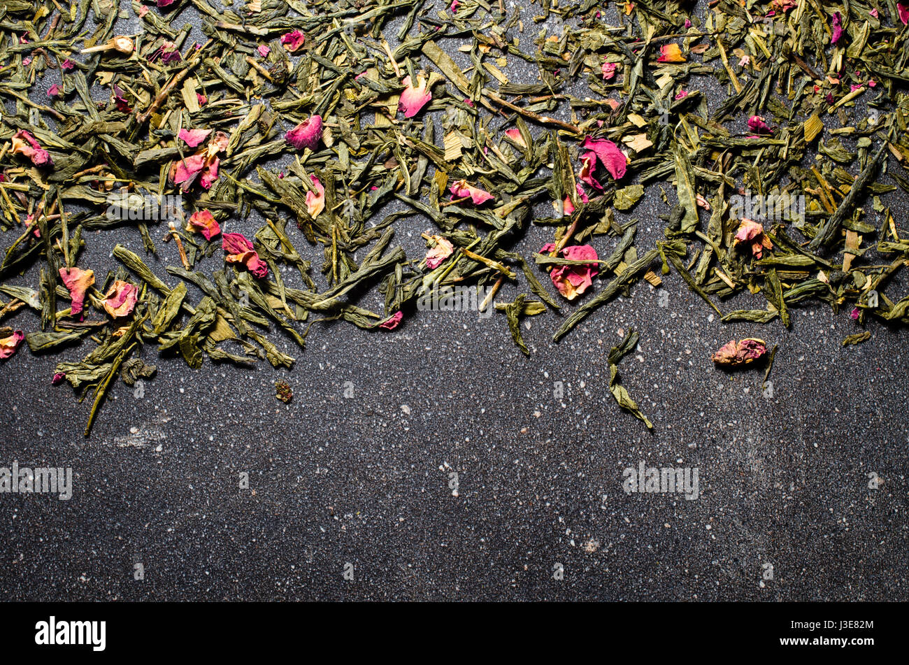 Tea leaves on dark table Stock Photo - Alamy