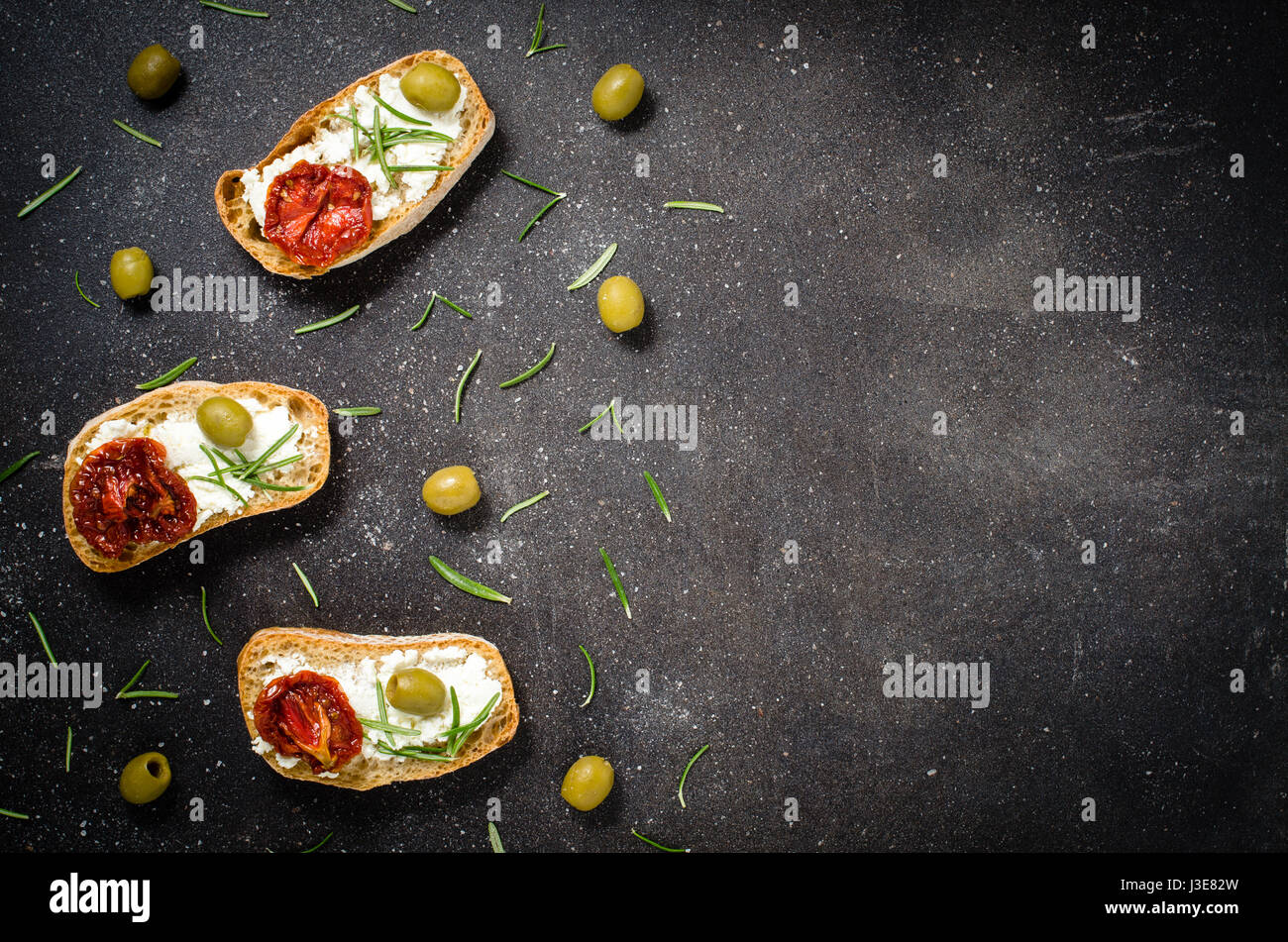 Overhead shot of mini sandwiches on dark table Stock Photo - Alamy