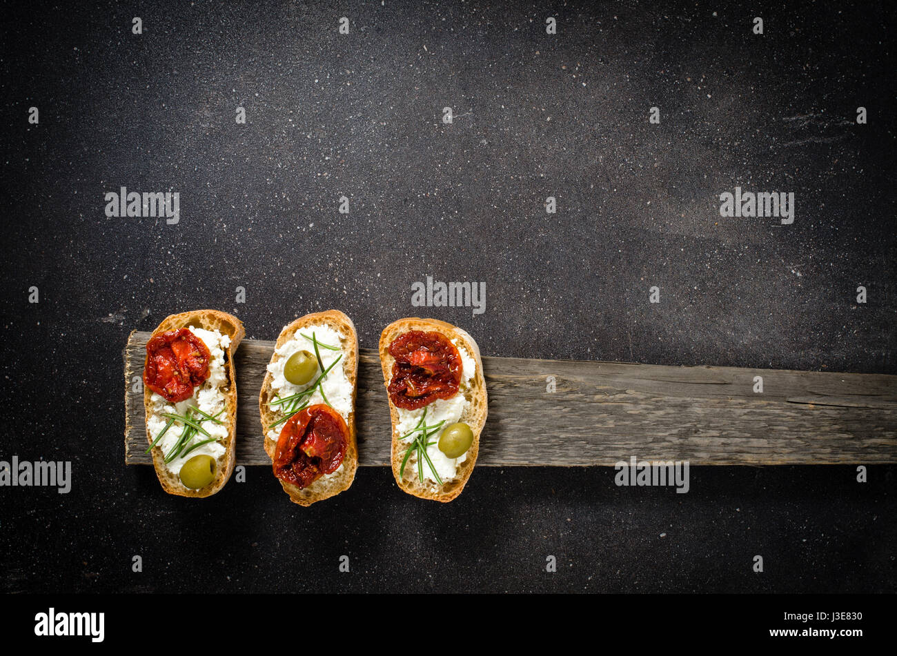 Overhead shot of mini sandwiches on dark table Stock Photo - Alamy