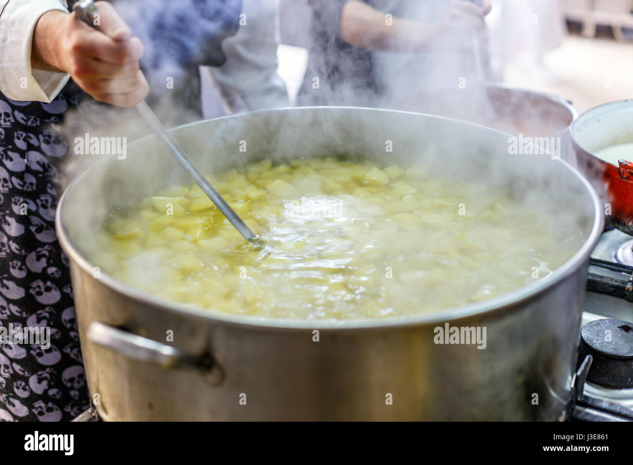 Chef is cooking soup in the big cooker at the restaurant kitchen Stock ...