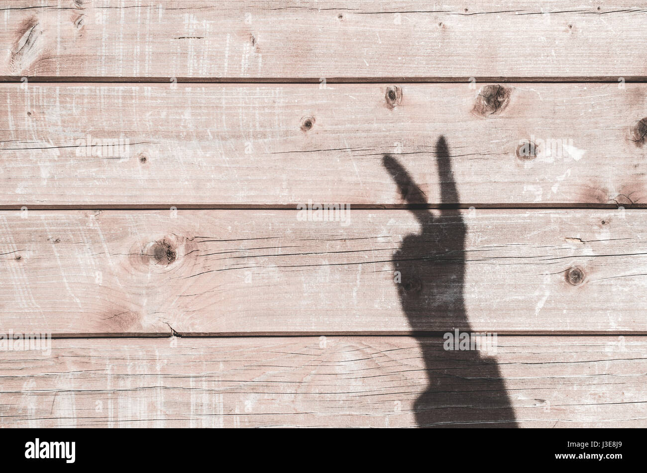 Shadow in shape of peace symbol on an old wooden background Stock Photo ...
