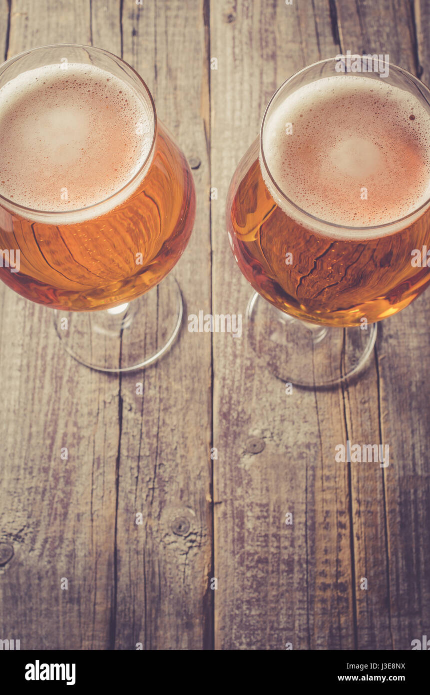 Overhead shot of beer glasses on an old wooden table Stock Photo - Alamy
