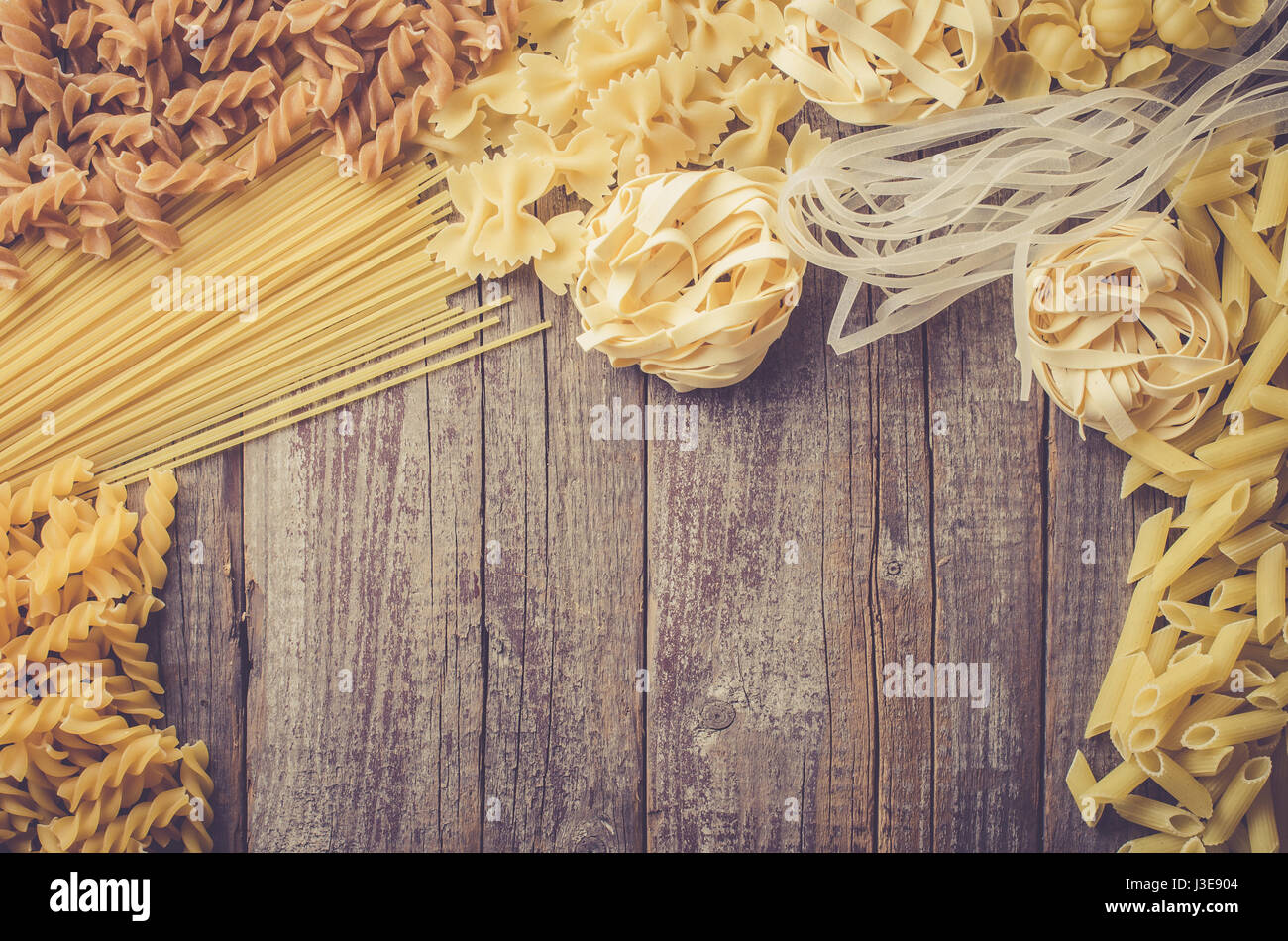 Mix of pasta on an old wooden table Stock Photo - Alamy