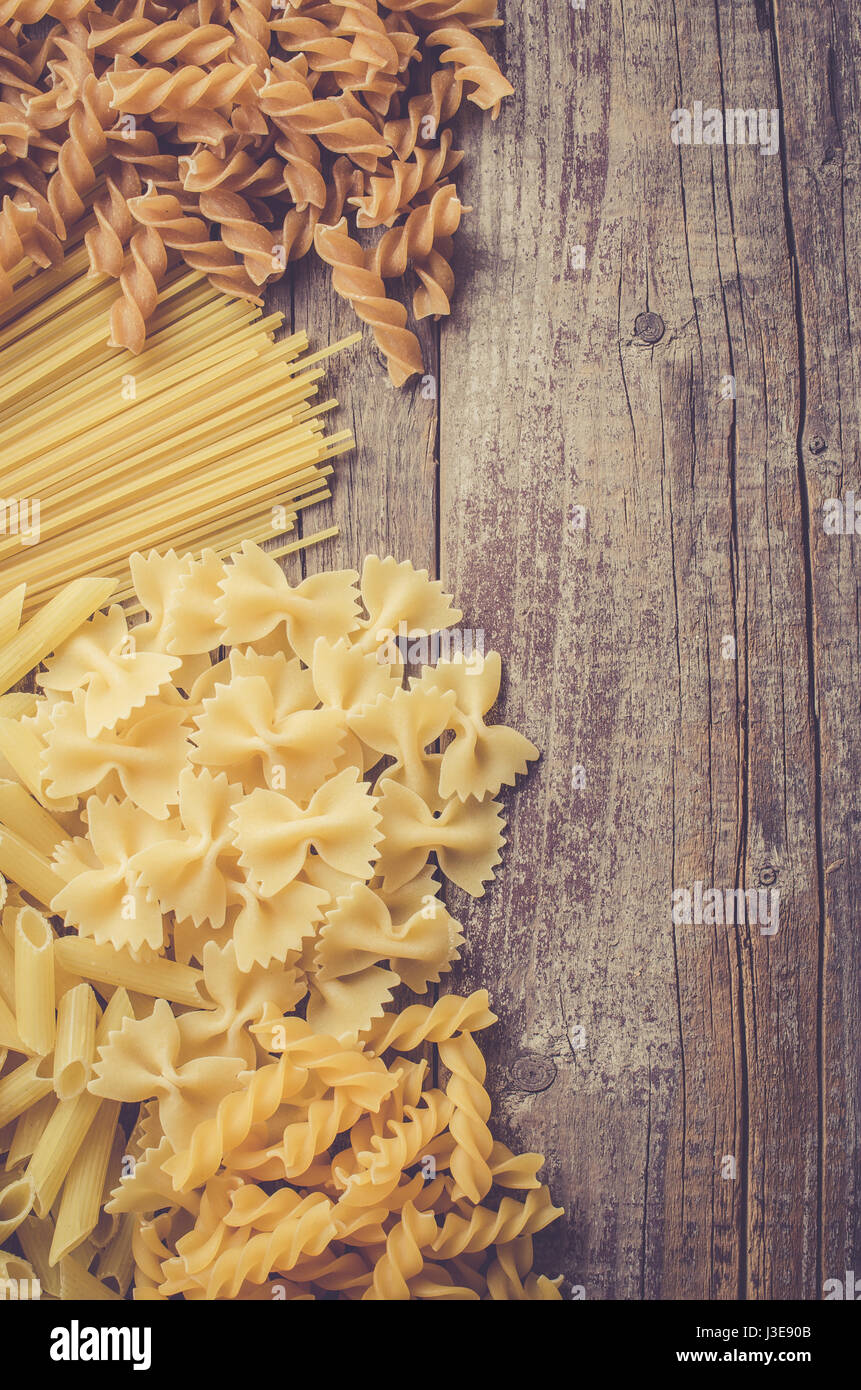 Mix of pasta on an old wooden table Stock Photo - Alamy