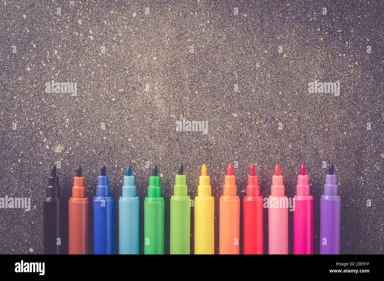 Colorful markers on dark background. Close up Stock Photo - Alamy