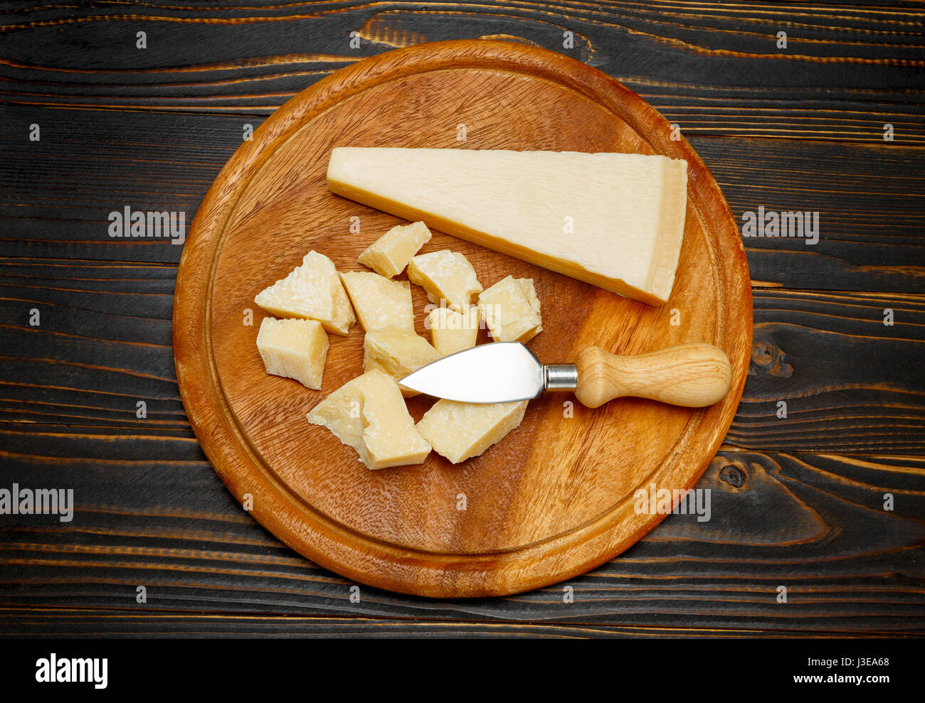 parmesan cheese on wooden background Stock Photo - Alamy