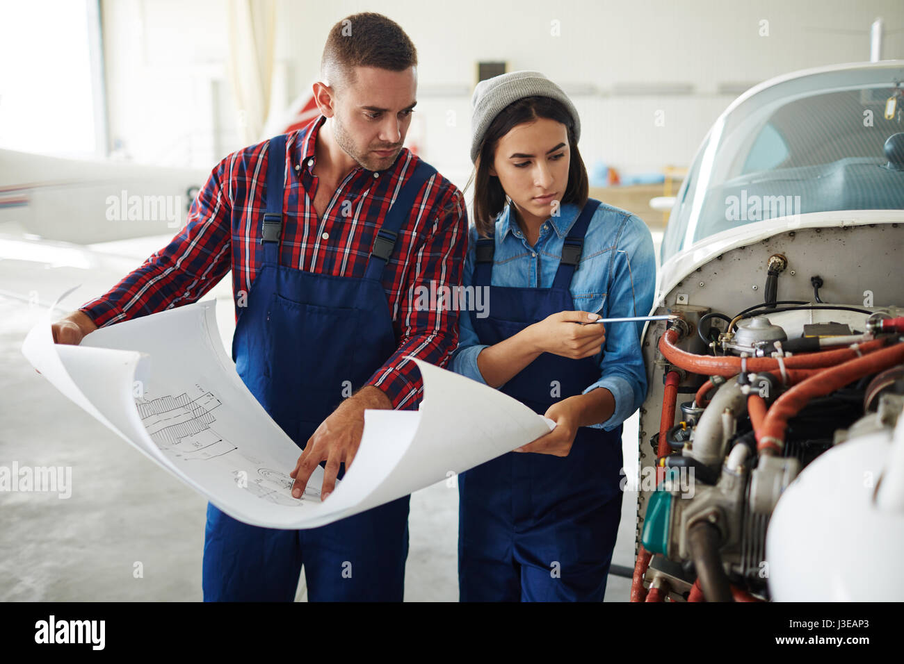 Aircraft Service Crew Inspecting Plane Stock Photo - Alamy