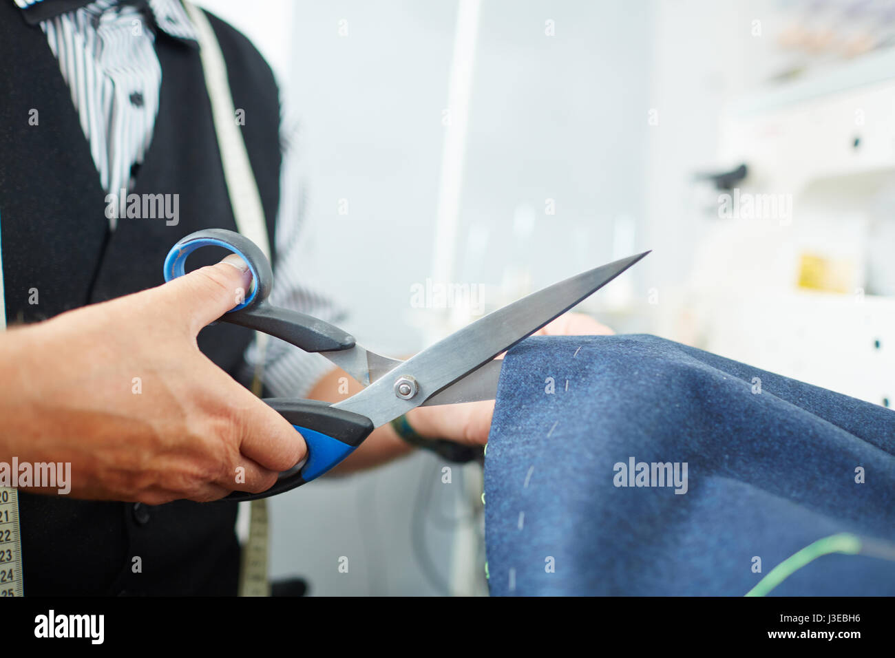 Tailor cutting cloth hi-res stock photography and images - Alamy