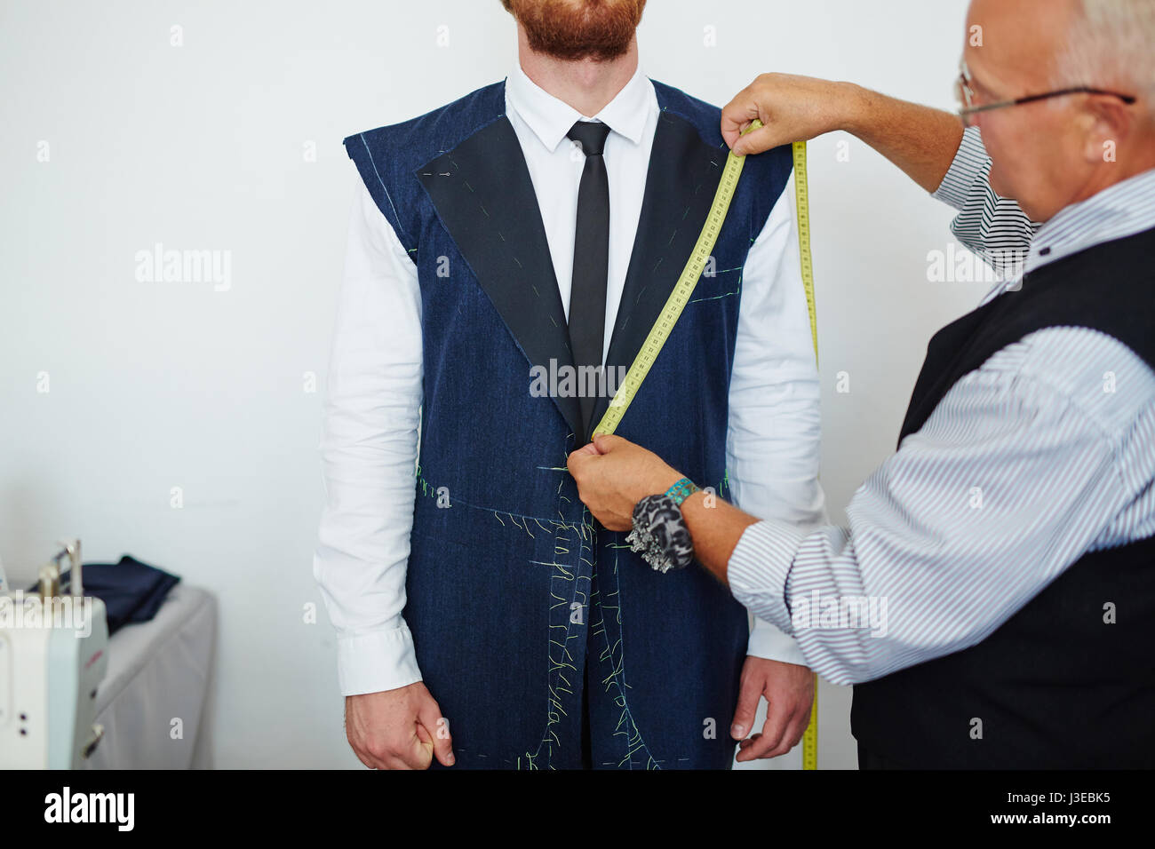 Old Tailor Measuring Model in Atelier Studio Stock Photo - Alamy
