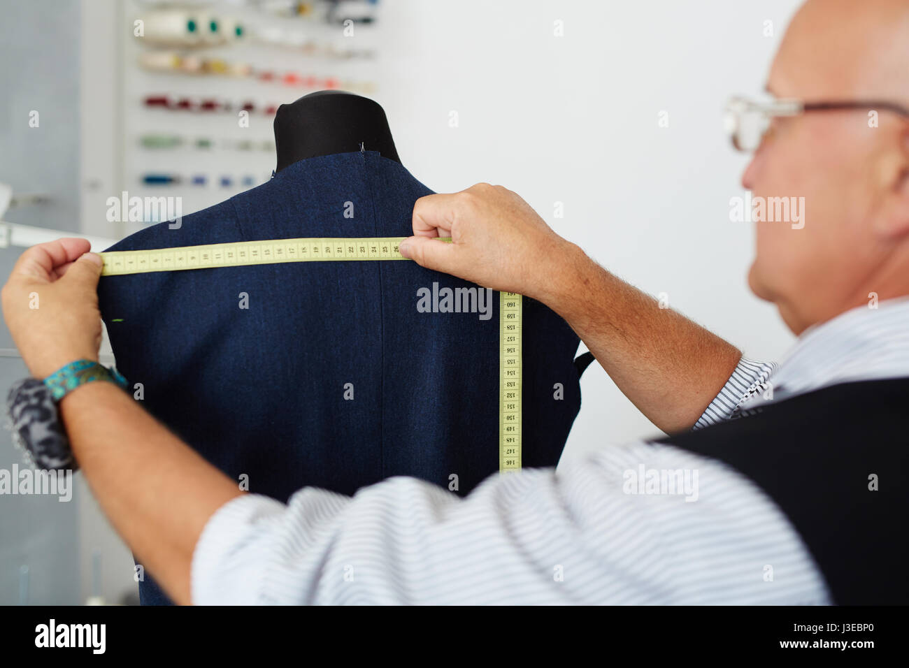 Old fashioned Tailor Taking Measurements Stock Photo - Alamy