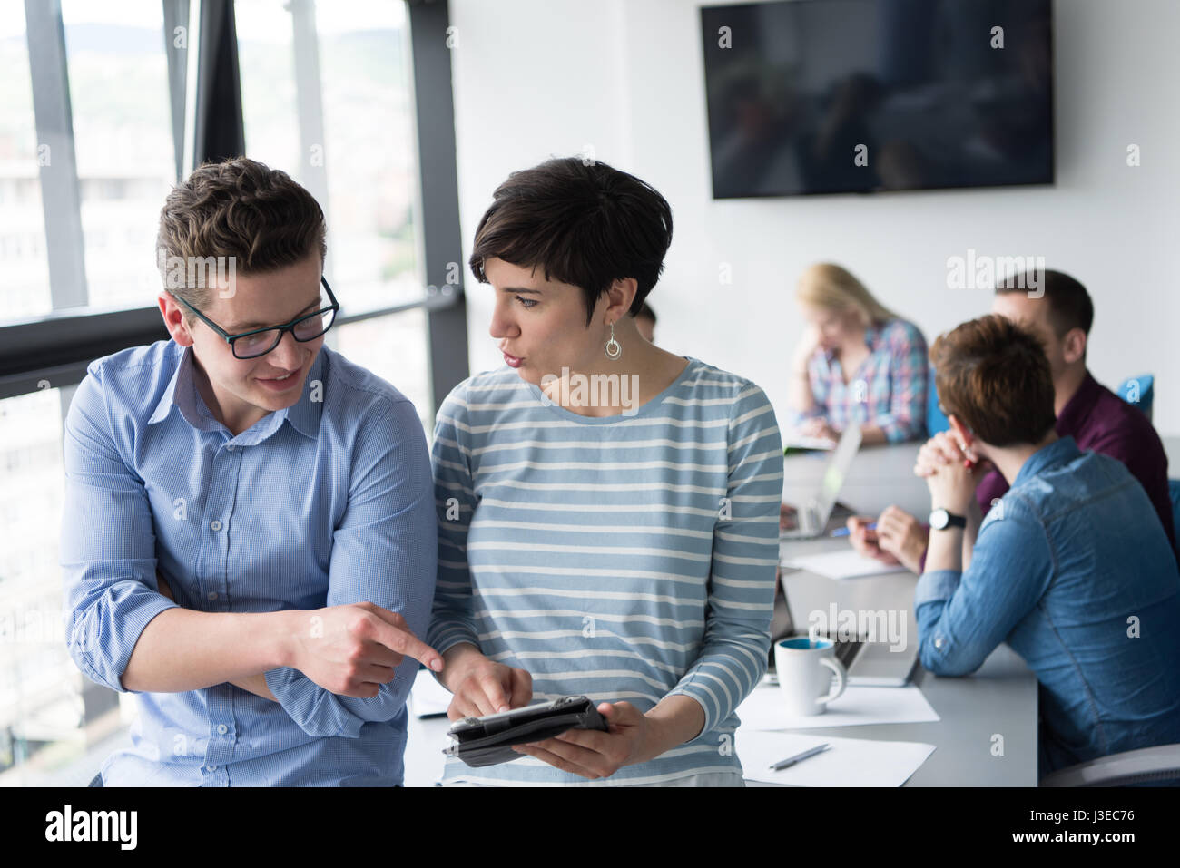 two business people using tablet preparing for next meeting and ...