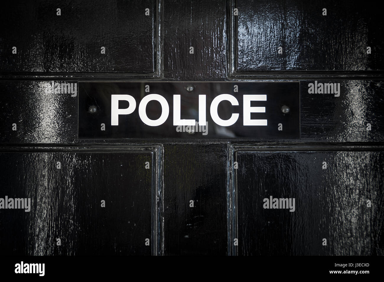 Police sign on black doorway at entrance to police station Stock Photo ...