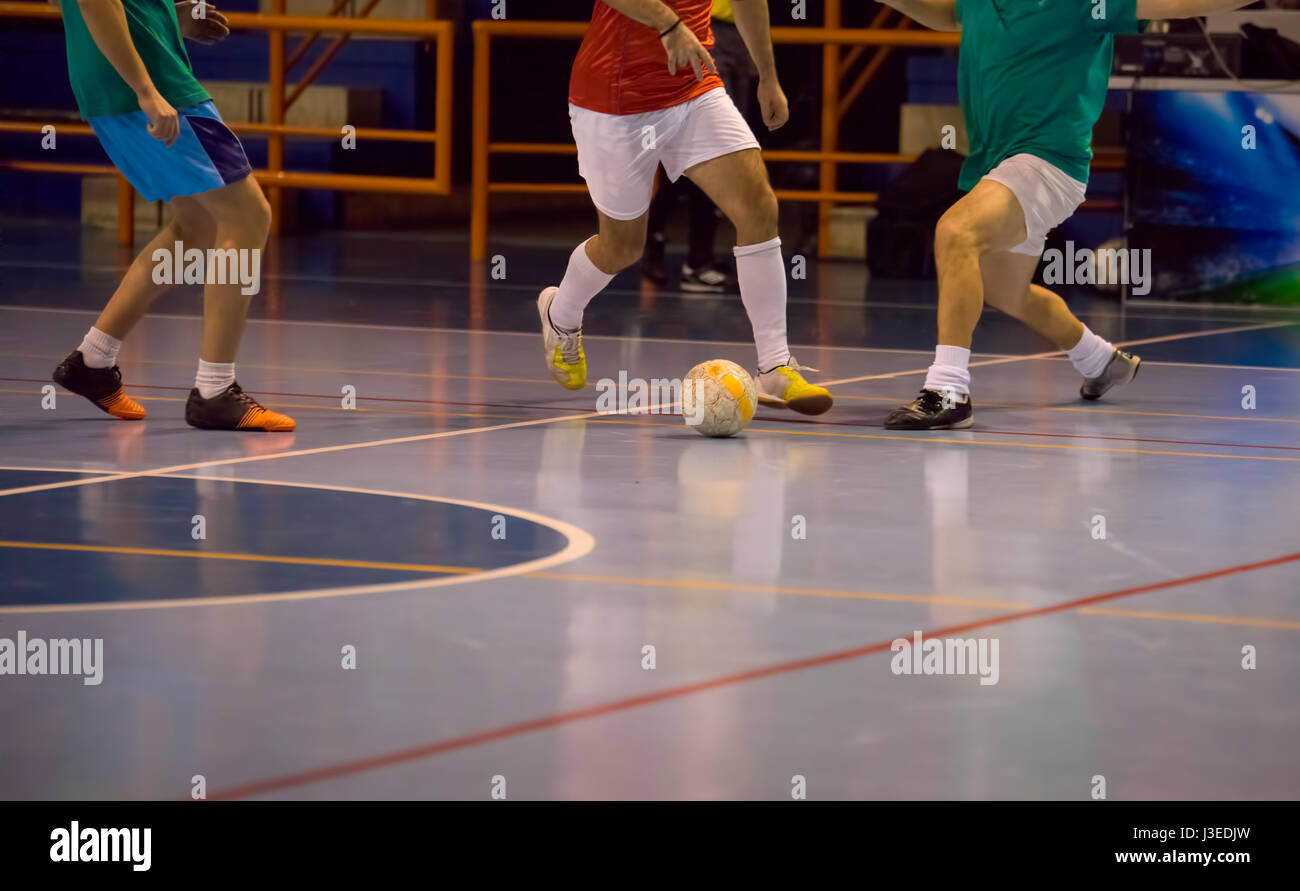 Futsal player with the ball in the sports hall Stock Photo - Alamy