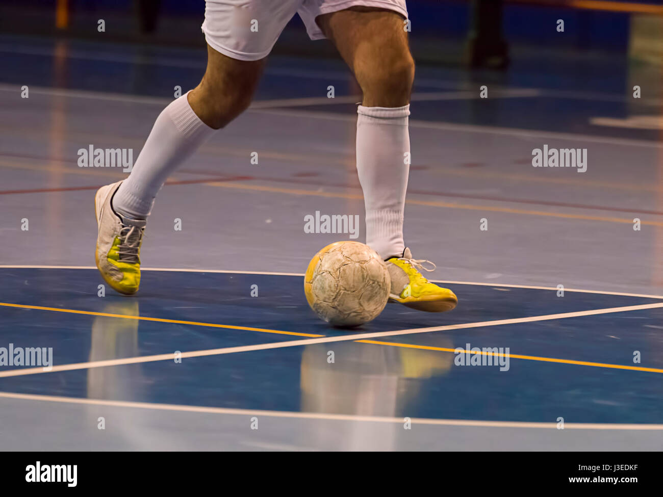 Futsal player with the ball in the sports hall Stock Photo - Alamy