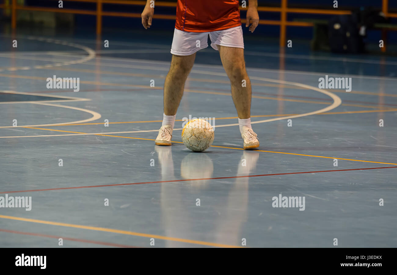 Futsal player with the ball in the sports hall Stock Photo - Alamy