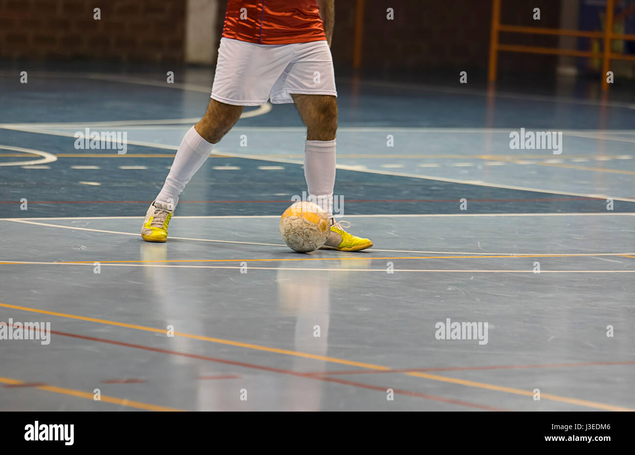 Futsal player with the ball in the sports hall Stock Photo - Alamy
