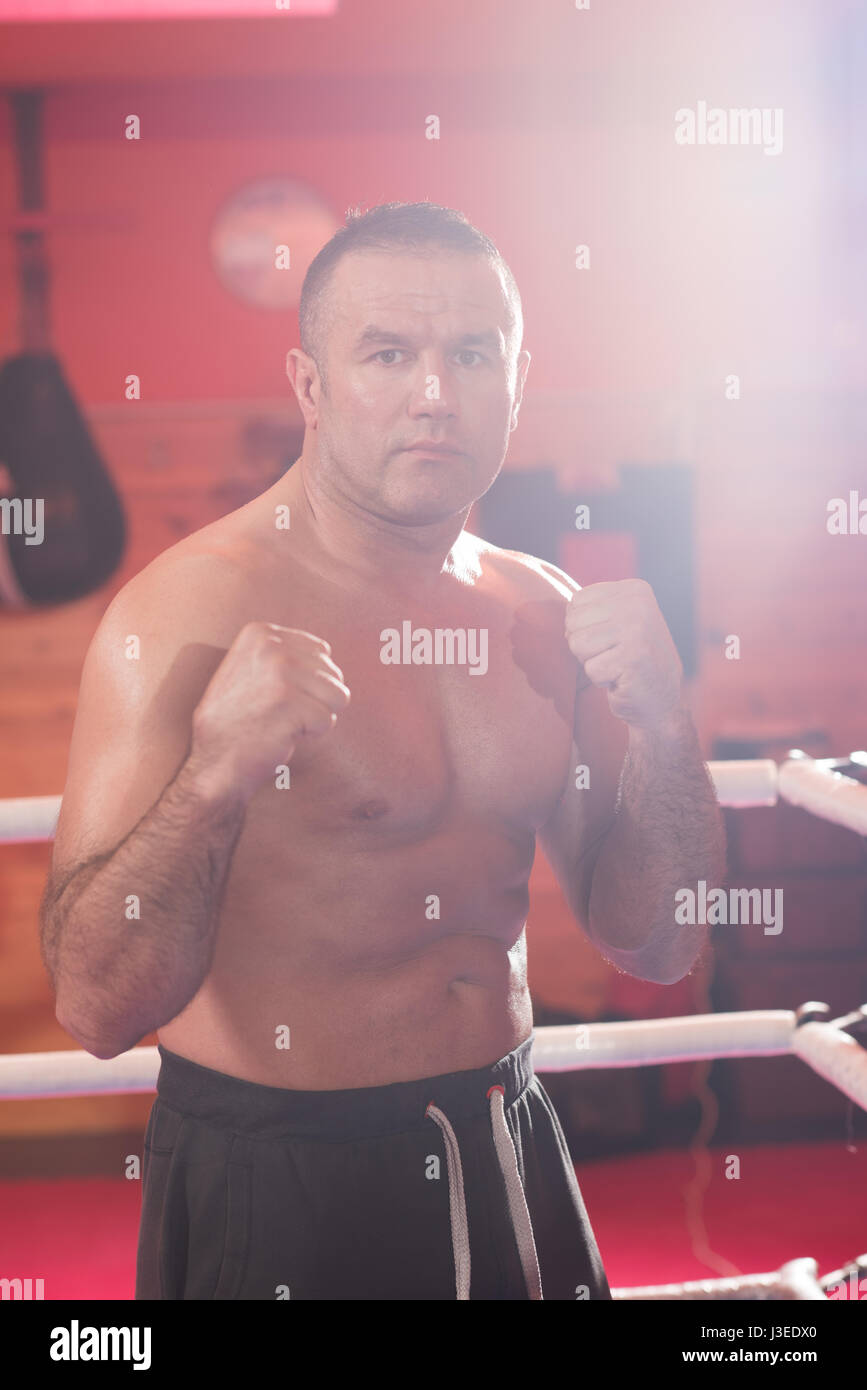 professional kickboxer with hands in martial arts position training for ...