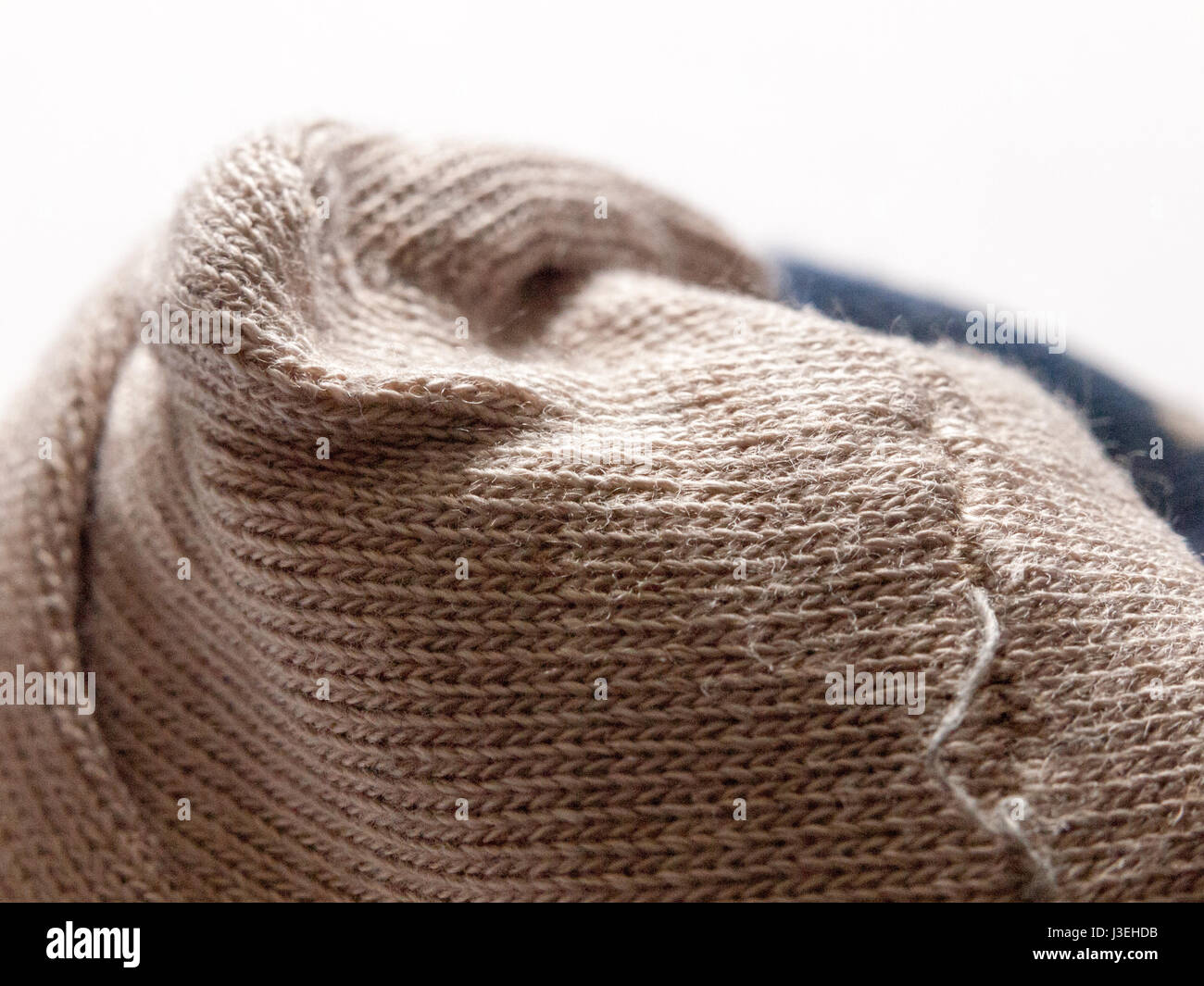 close up texture of warm soft sock end made of cotton wool beige ...