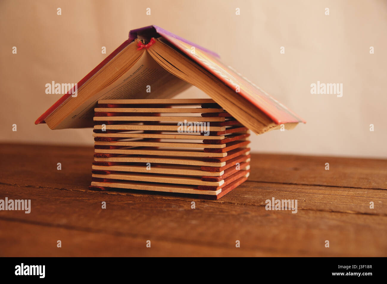 Background of wooden sticks in the form of a house on wood table brown ...