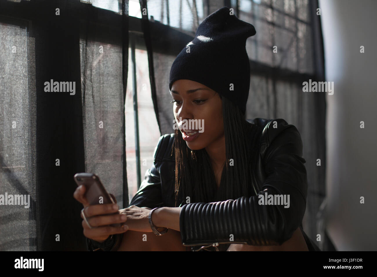 Beautiful young woman using her phone Stock Photo - Alamy