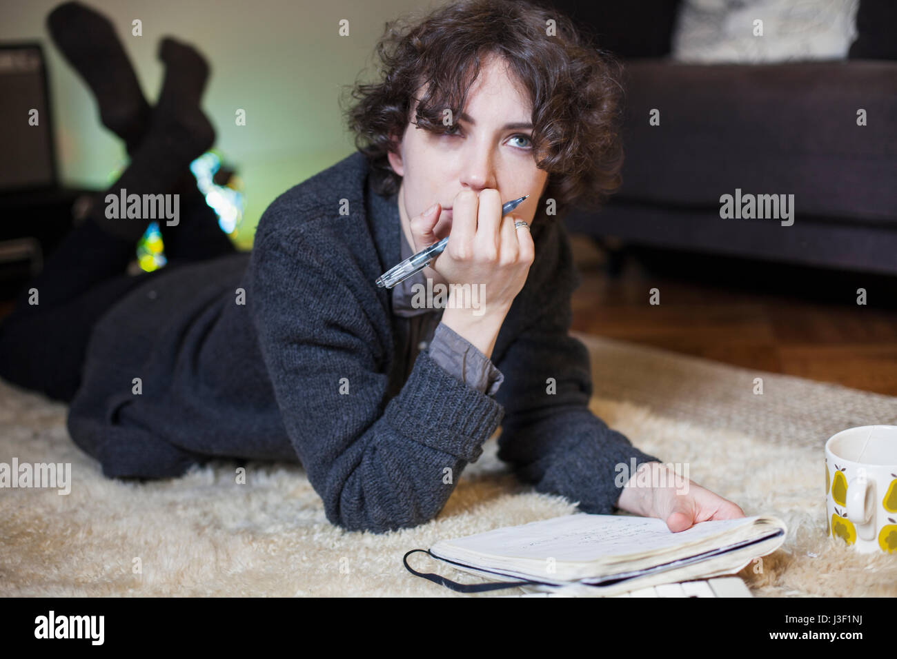 Young woman writing music Stock Photo - Alamy