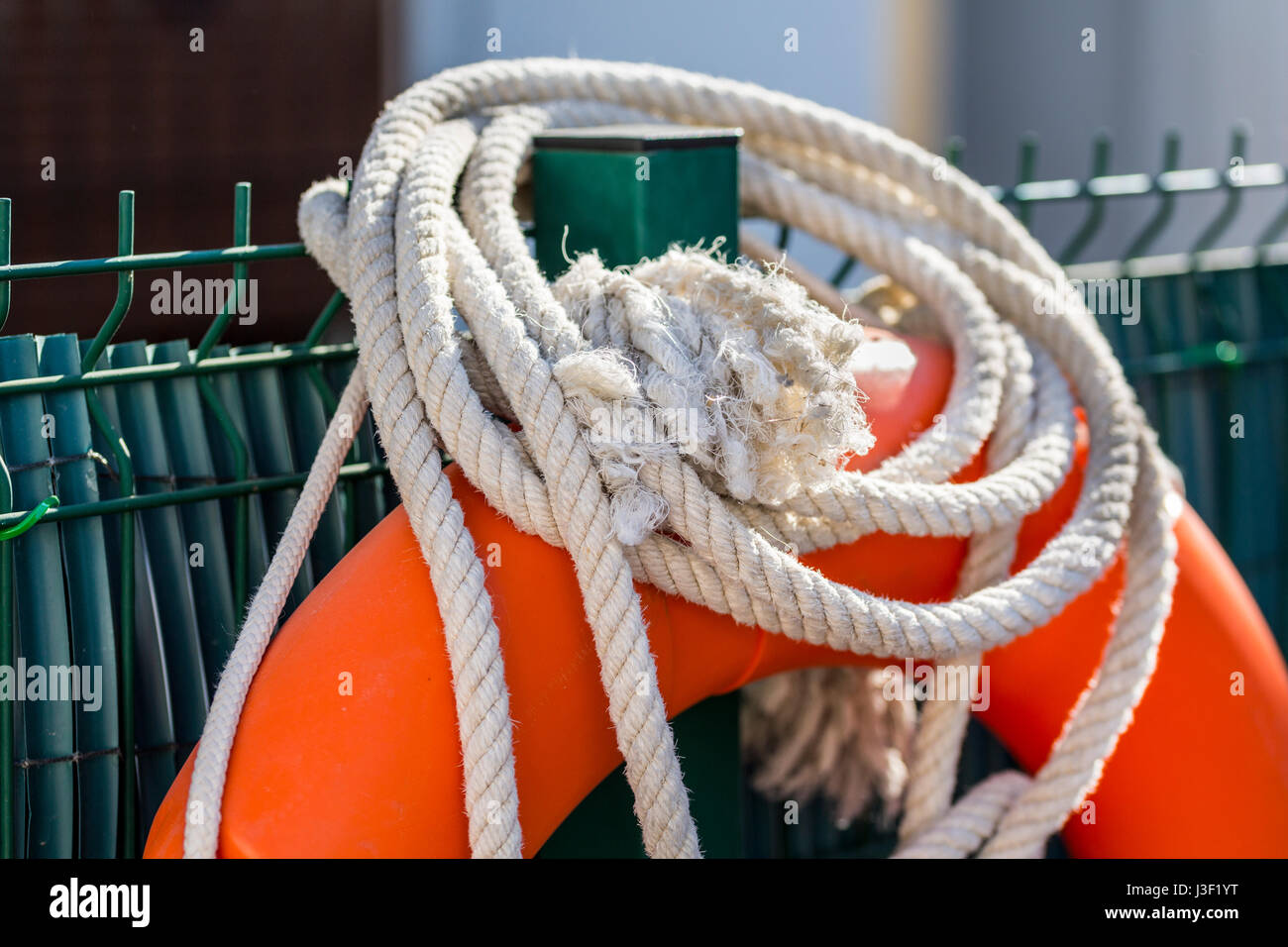 Detail of white rope and float in the lifeguard post of a swimming pool ...