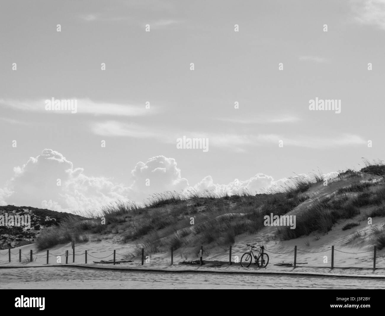 A bicycle parked by some sand dunes Stock Photo - Alamy