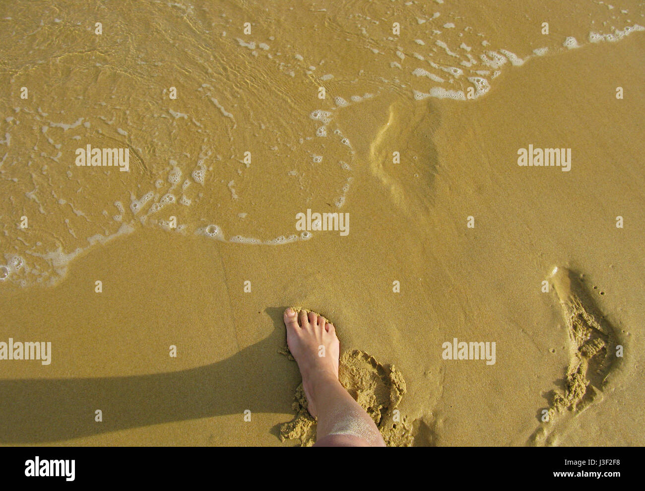 foot and footsteps in the sand Stock Photo - Alamy