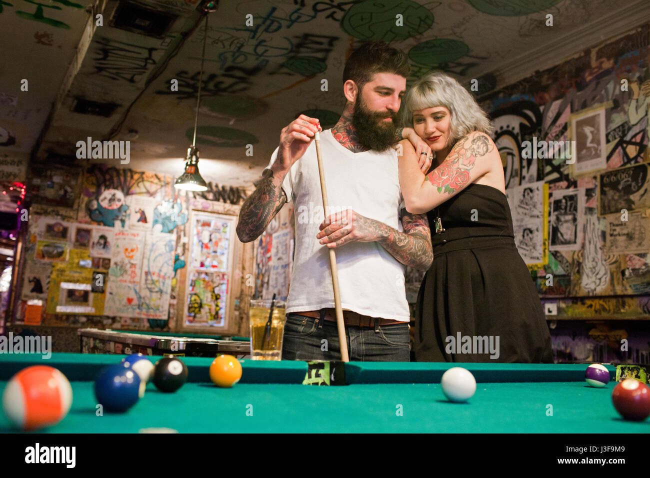 Young couple playing pool Stock Photo - Alamy