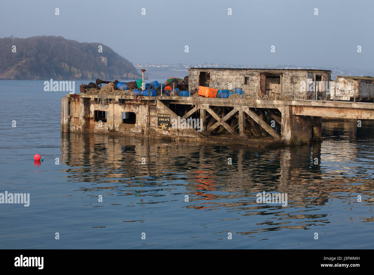 Old abandoned jetty at Brixham Harbour in Devon, UK on a sunny day ...