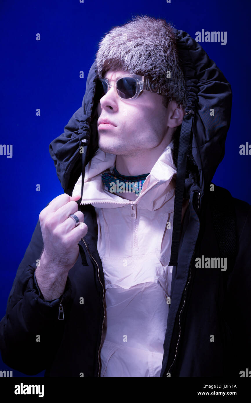 one young adult man, fashion photography, man, blue color background ...