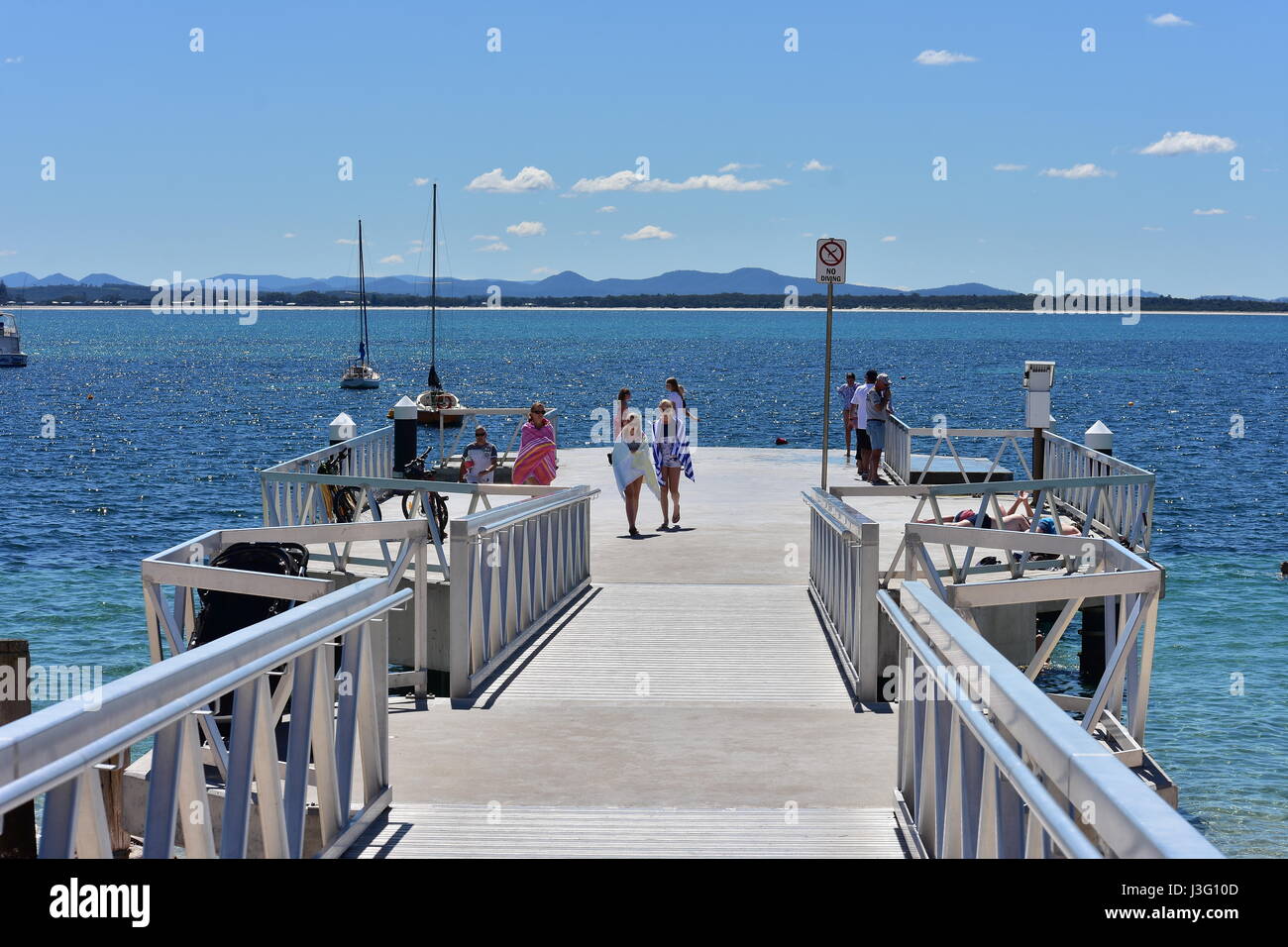 Wharf in Shoal Bay under bright noon light with Shoal Bay and Jimmys ...