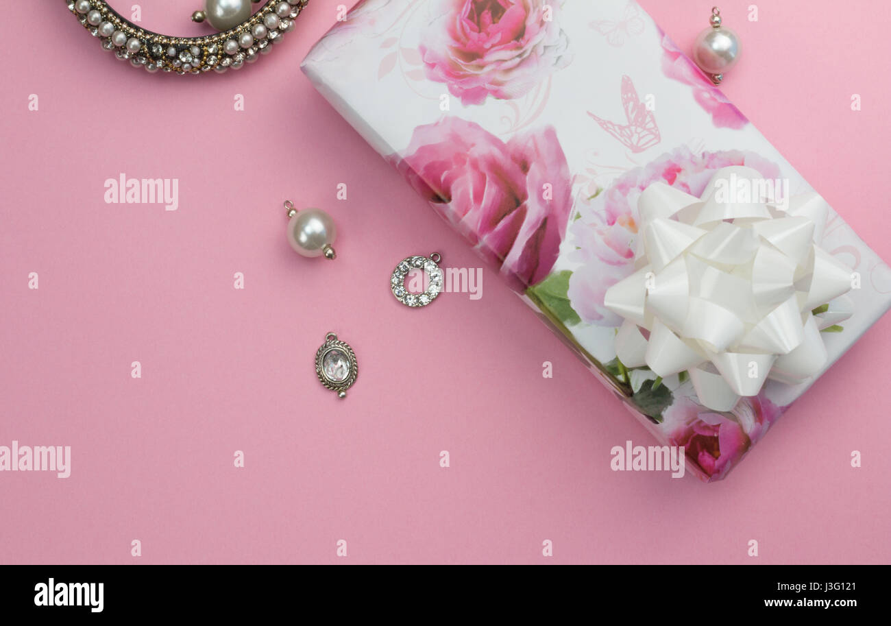 Celebration pink background with isolated rose gift wrapped present ...