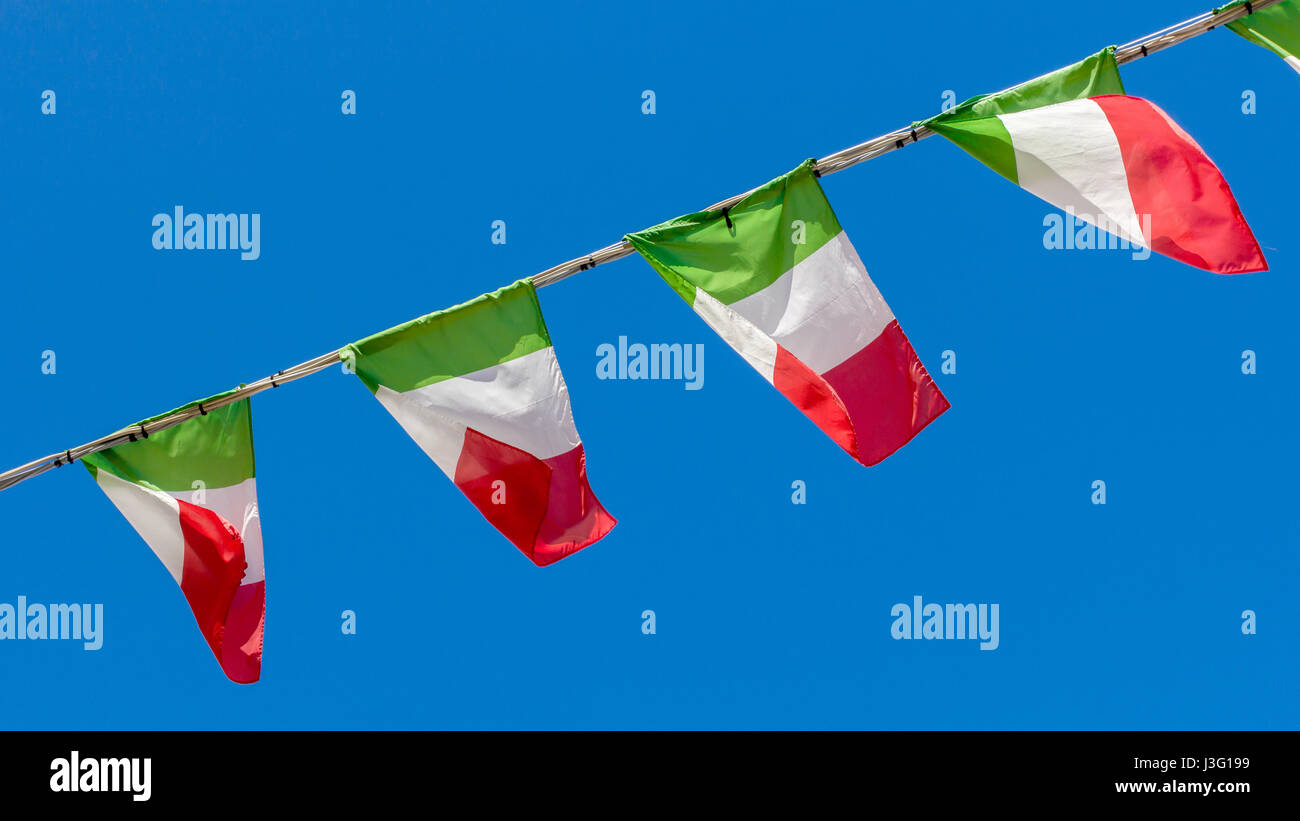 Small Italian flags related to a high-tension wire Stock Photo - Alamy