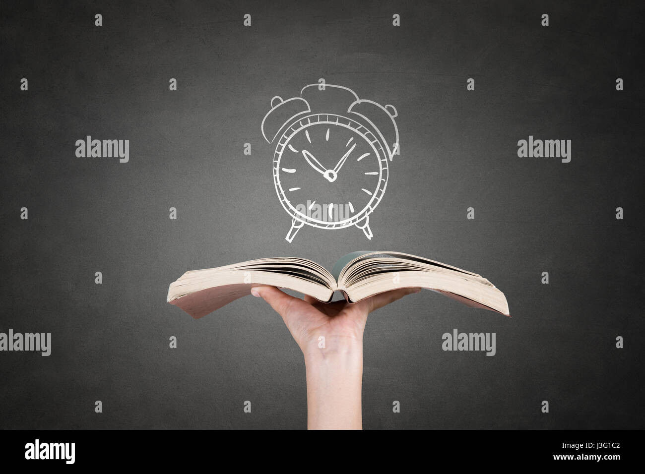 Human hand holding book with clock. Concept of time management Stock ...