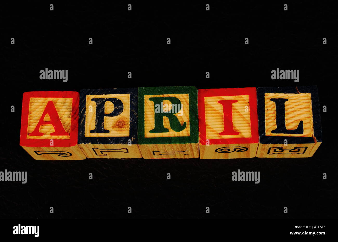 The term April visually displayed on a black background using colorful ...