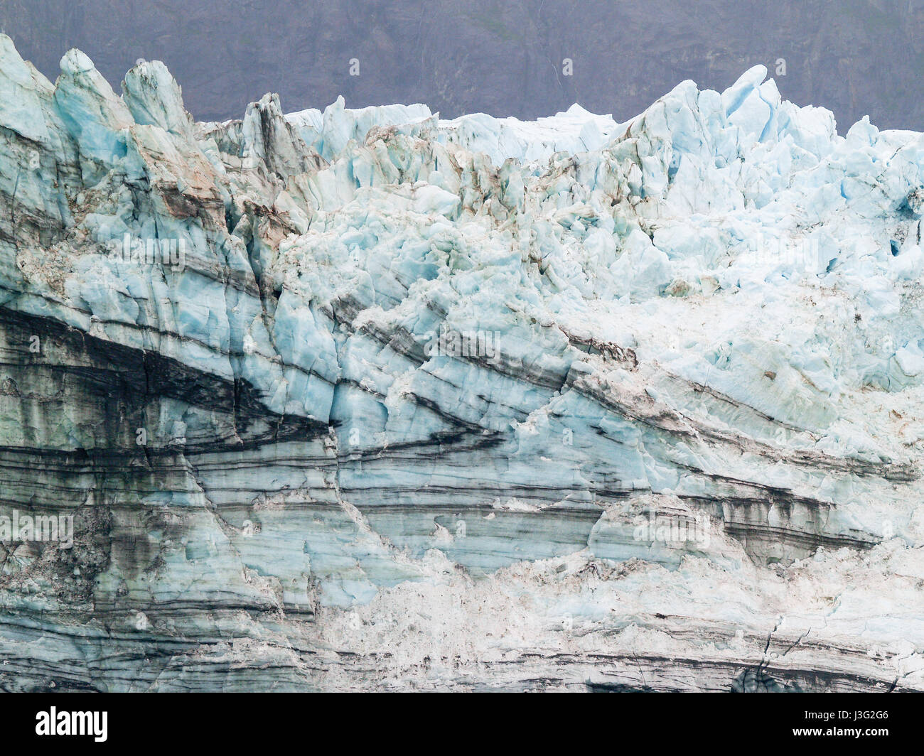 Glacier face with foliation pattern and black streaks Stock Photo - Alamy